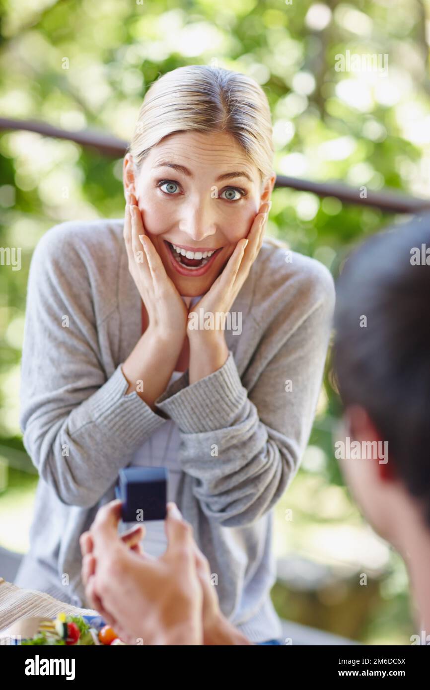 He finally did it. a beautiful young woman looking surprised as her ...