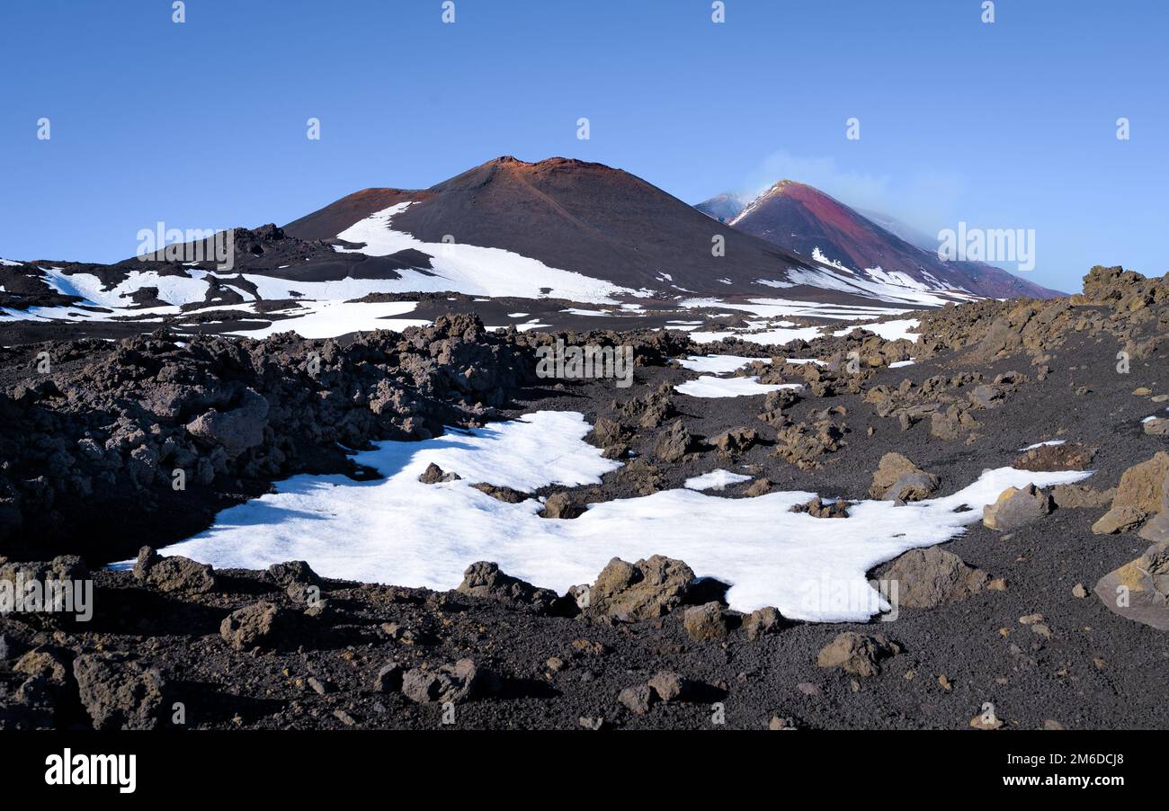 Moonscape of Mount Etna volcano smoking craters in a snow-covered ...