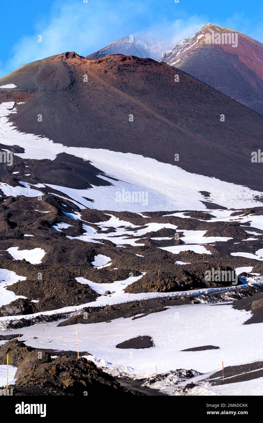 Moonscape of Mount Etna volcano smoking craters in a snow-covered ...
