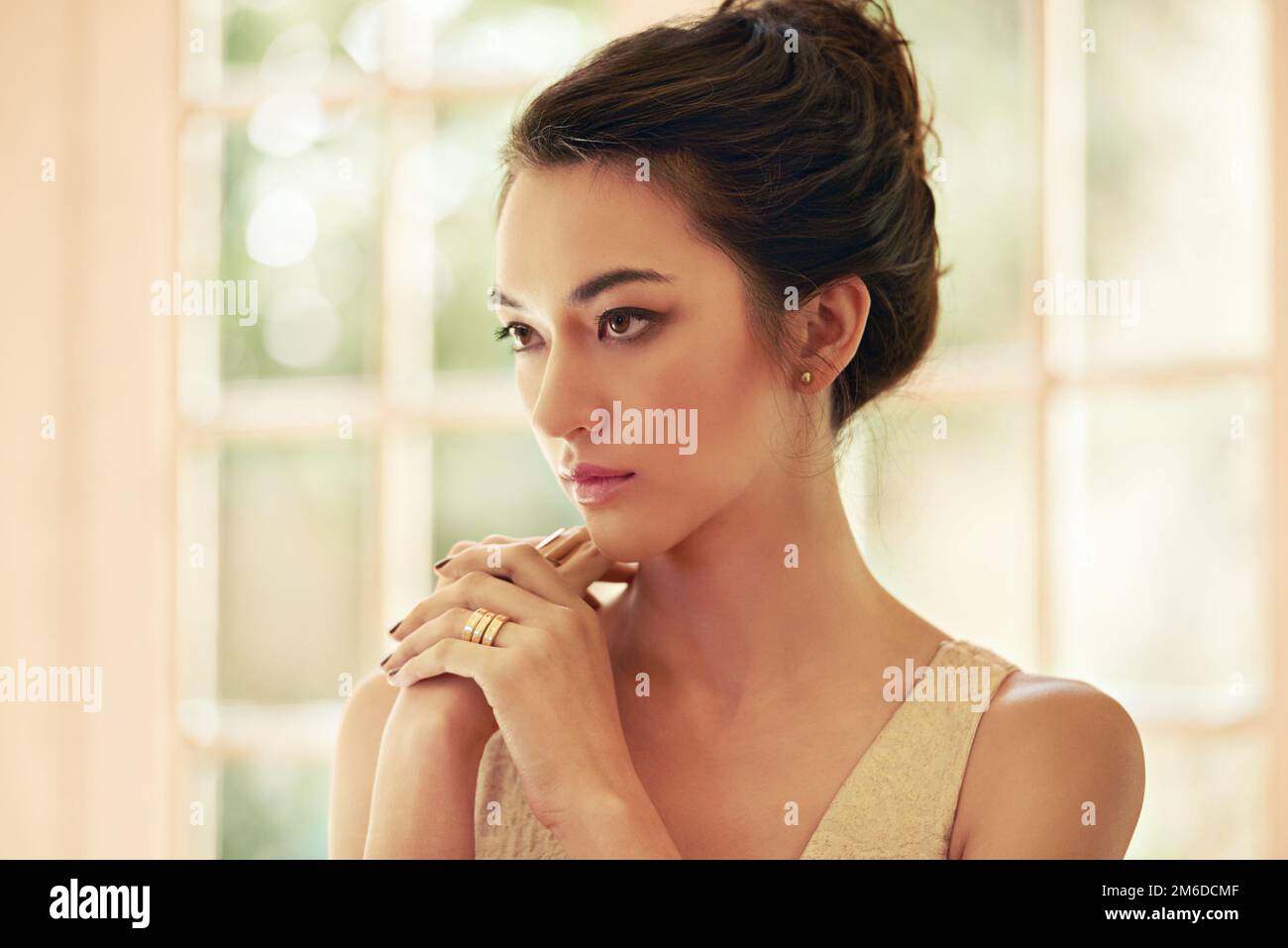Her beauty is alluring. a beautiful young woman dressed elegantly in ...