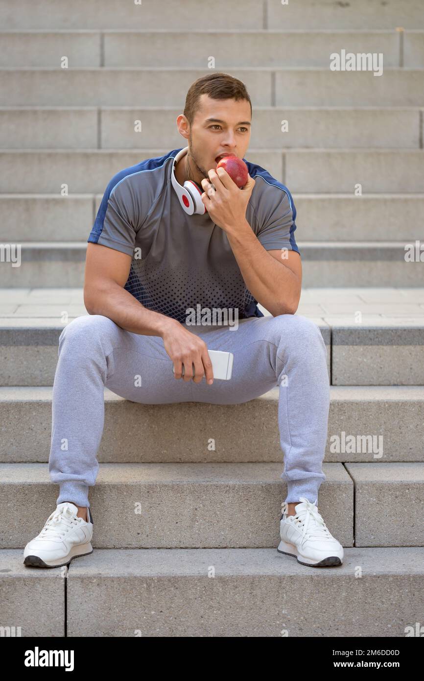 Eating apple fruit runner young man portrait format sports training ...