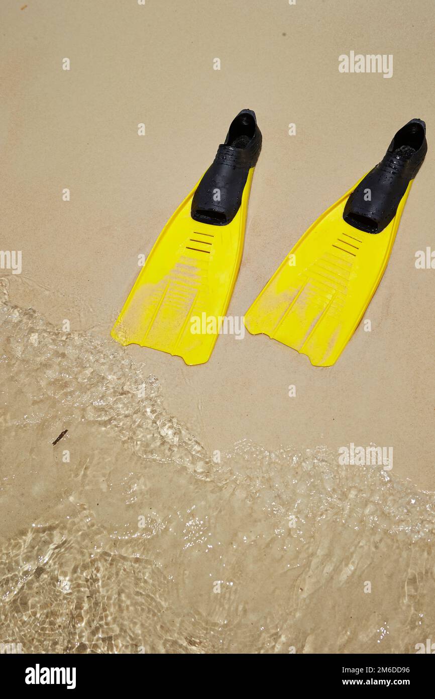 yellow flippers on the beach Stock Photo - Alamy