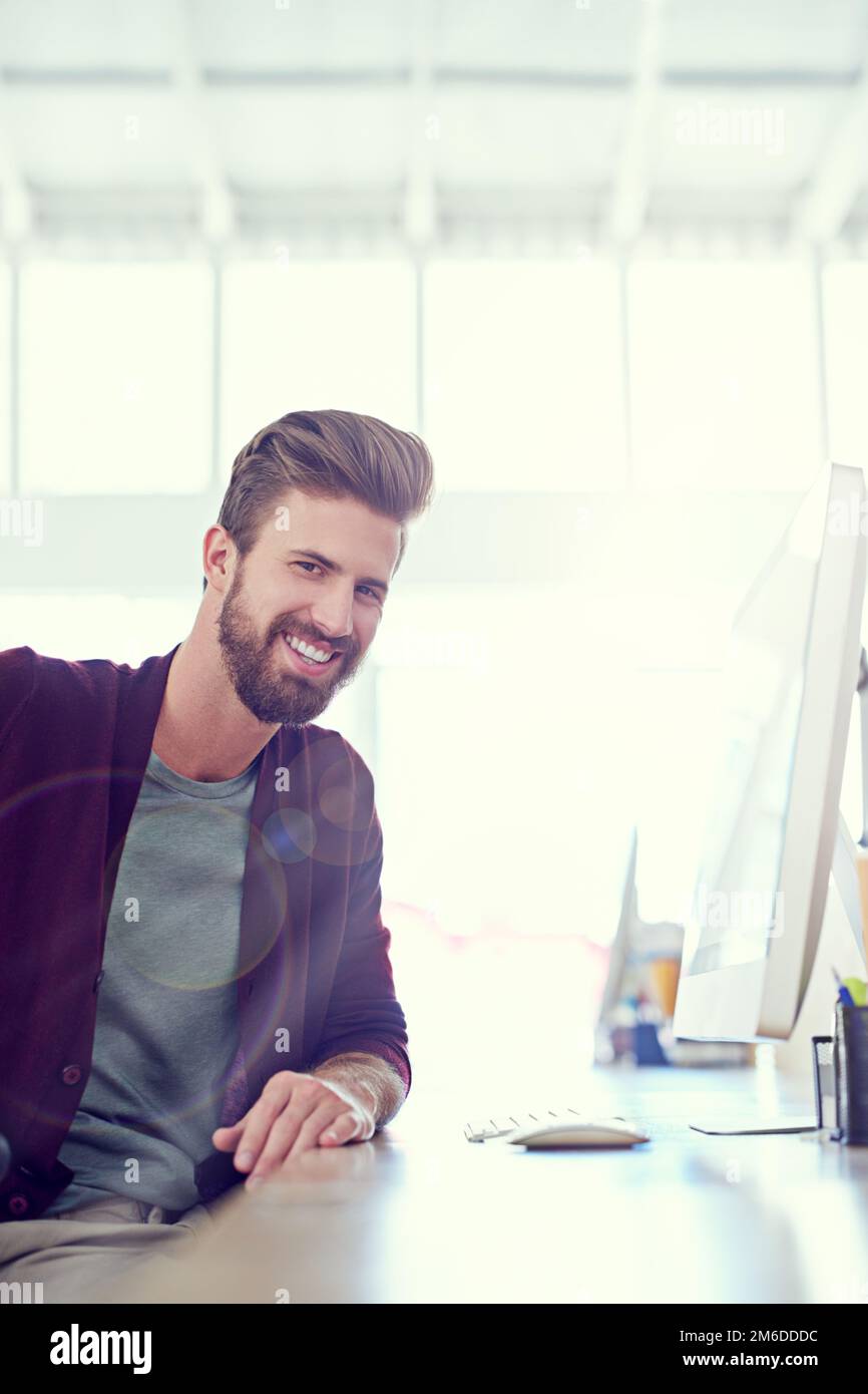 Designing the next big trend. Portrait of a young designer sitting at ...