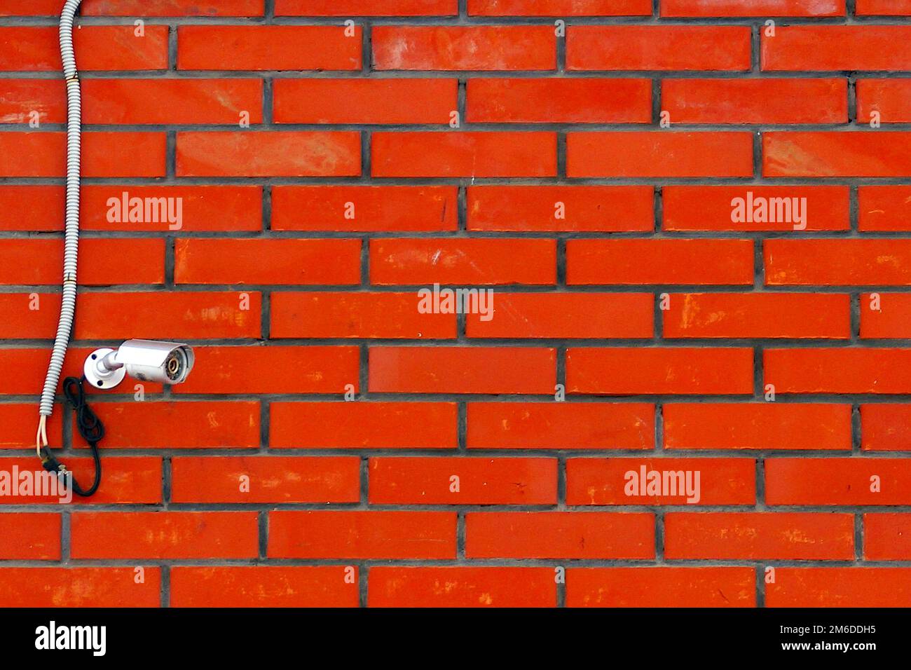 A CCTV security camera on the wall is monitoring Stock Photo - Alamy