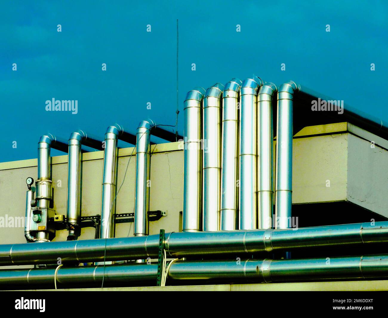 shiny stainless steel mechanical pipes on high roof`s mechanical ...
