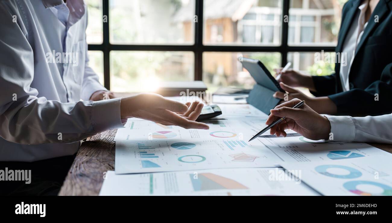 Asian business colleagues meeting to analyze financial reporting ...