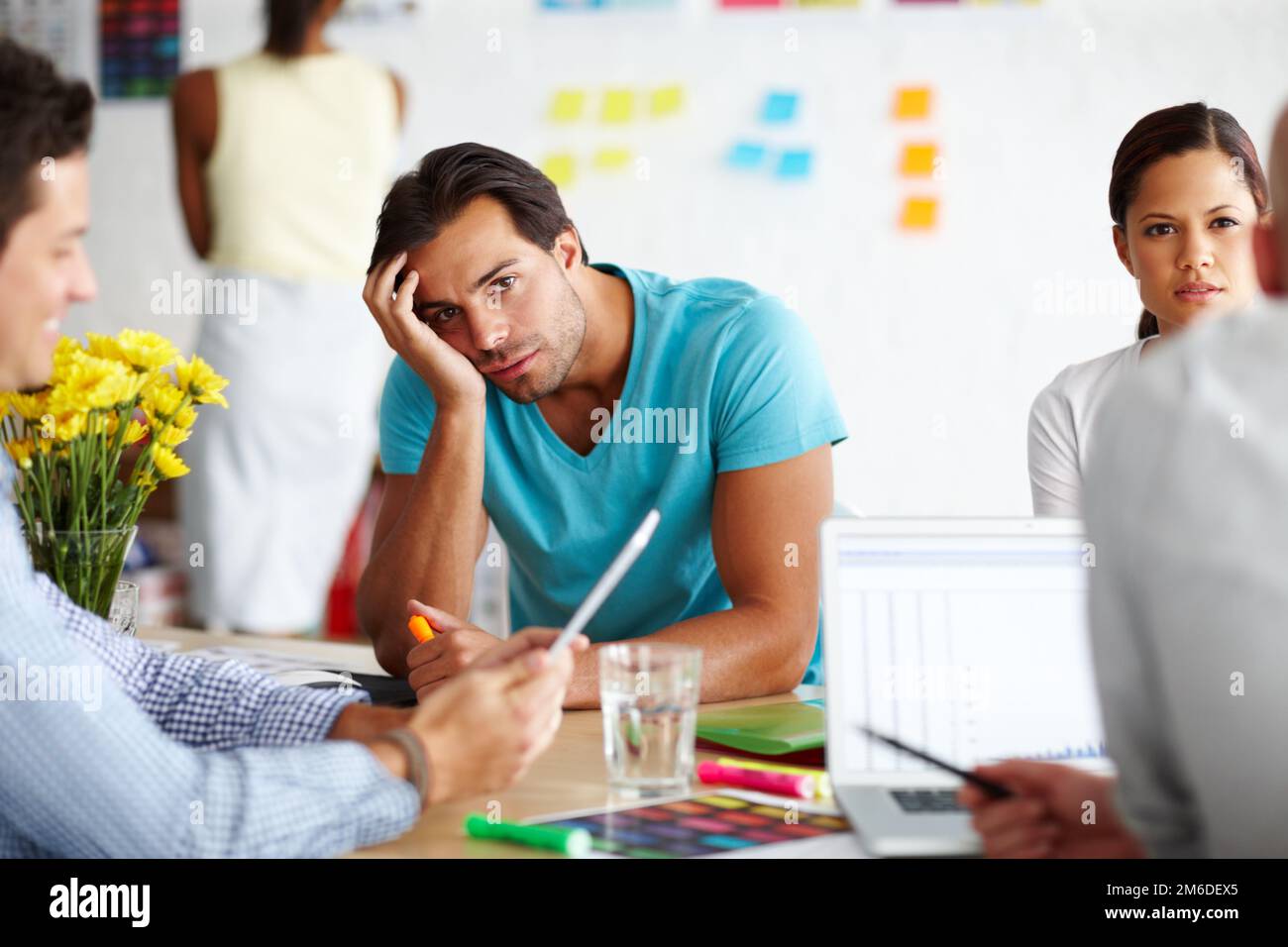 His creativity is crushed. Portrait of a bored looking man sitting at ...