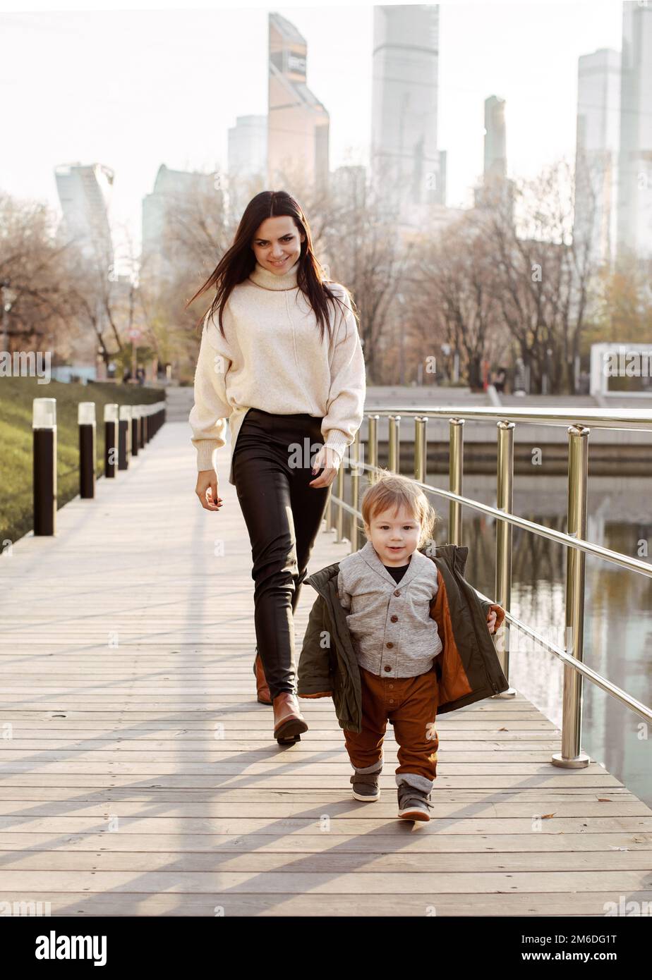 Young girl and a running child in a park Stock Photo - Alamy