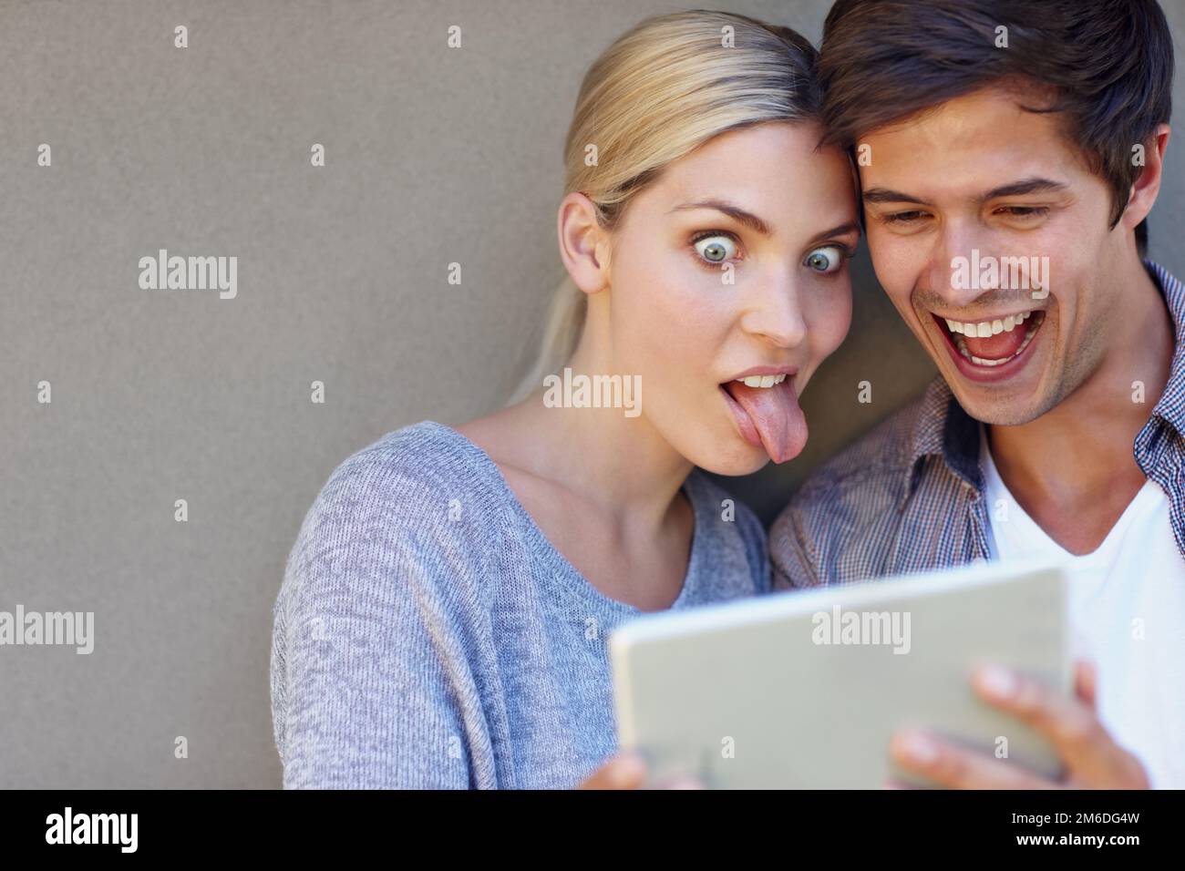 Getting their silly on. a playful young couple making funny faces ...