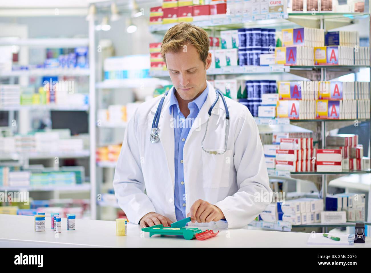 Counting out the right amount for the prescription. A pharmacist ...