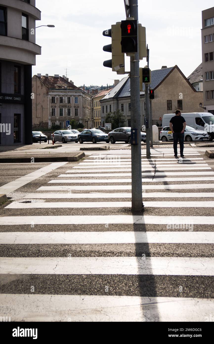 Crosswalk and traffic light with long shadow Stock Photo - Alamy