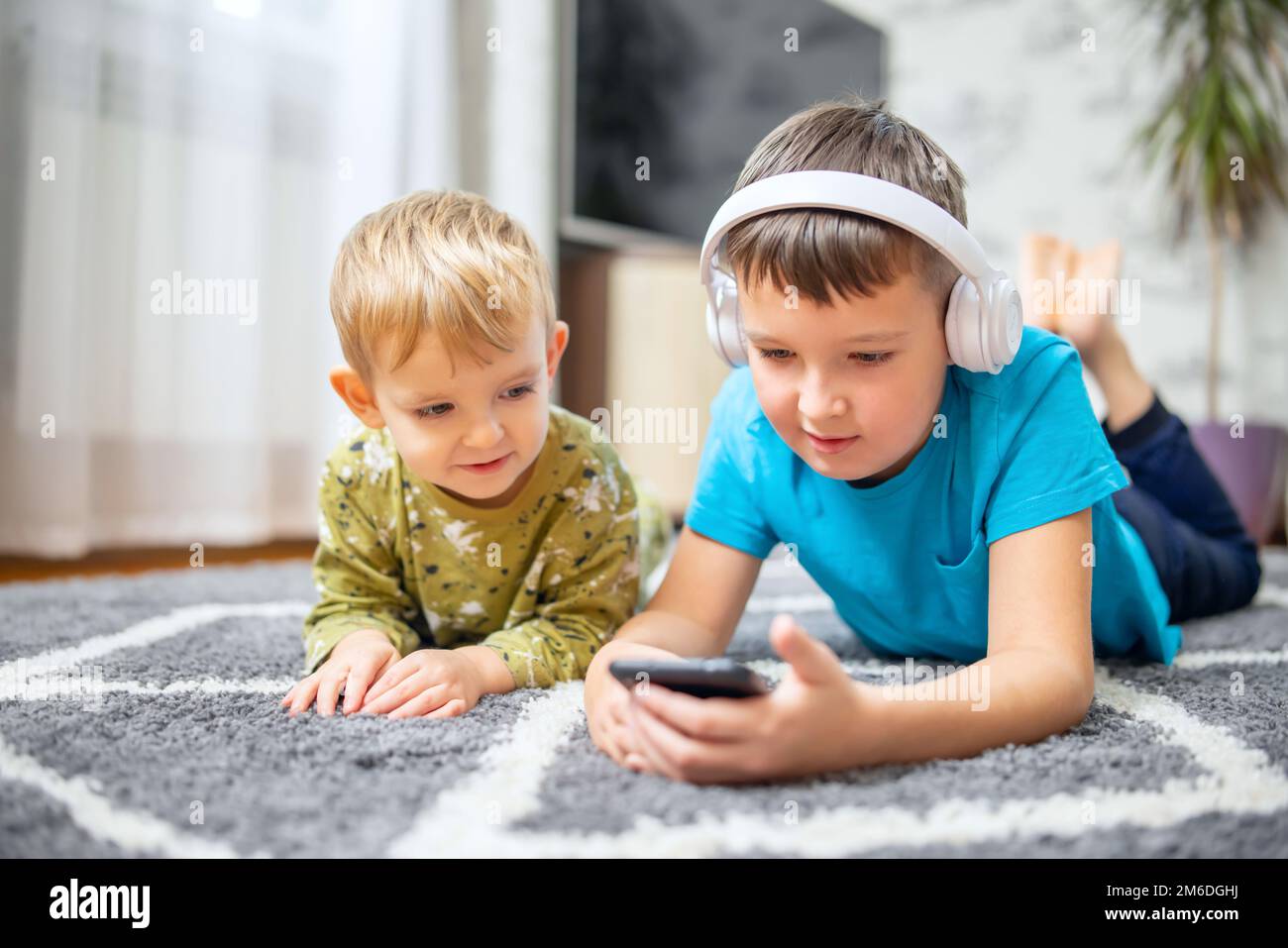 Two children watching smart phone, happy kids using smartphones ...