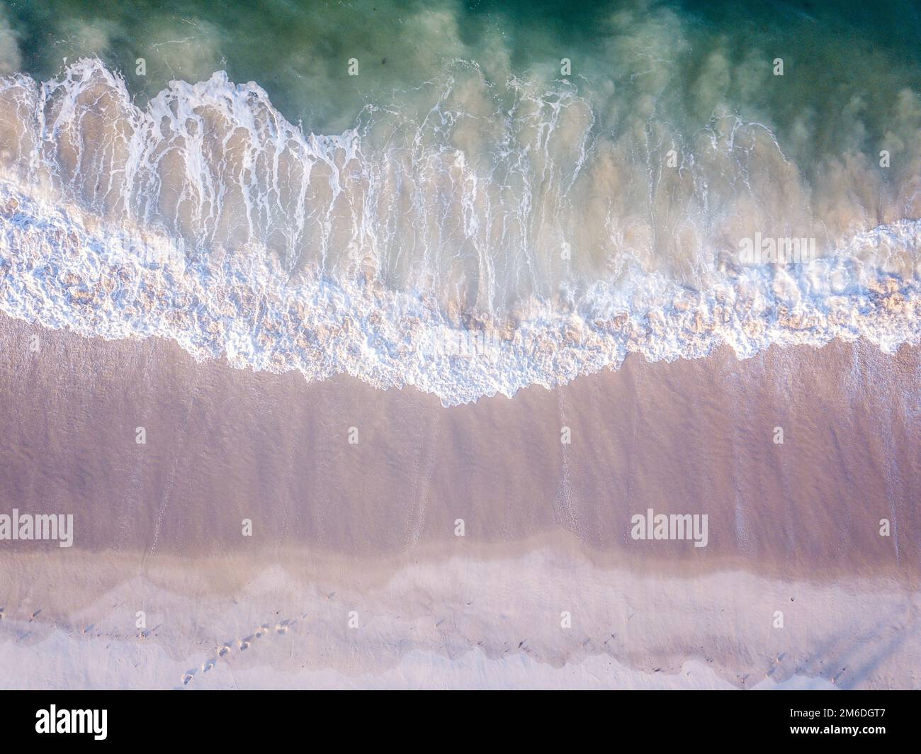 Drone picture of waves hitting the beach Stock Photo - Alamy