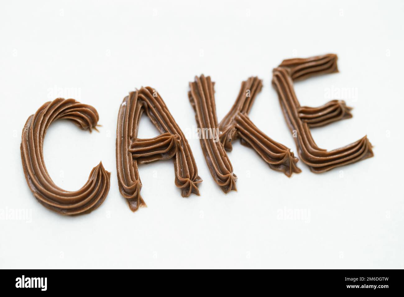 Cake words, words written with chocolate cream Stock Photo - Alamy