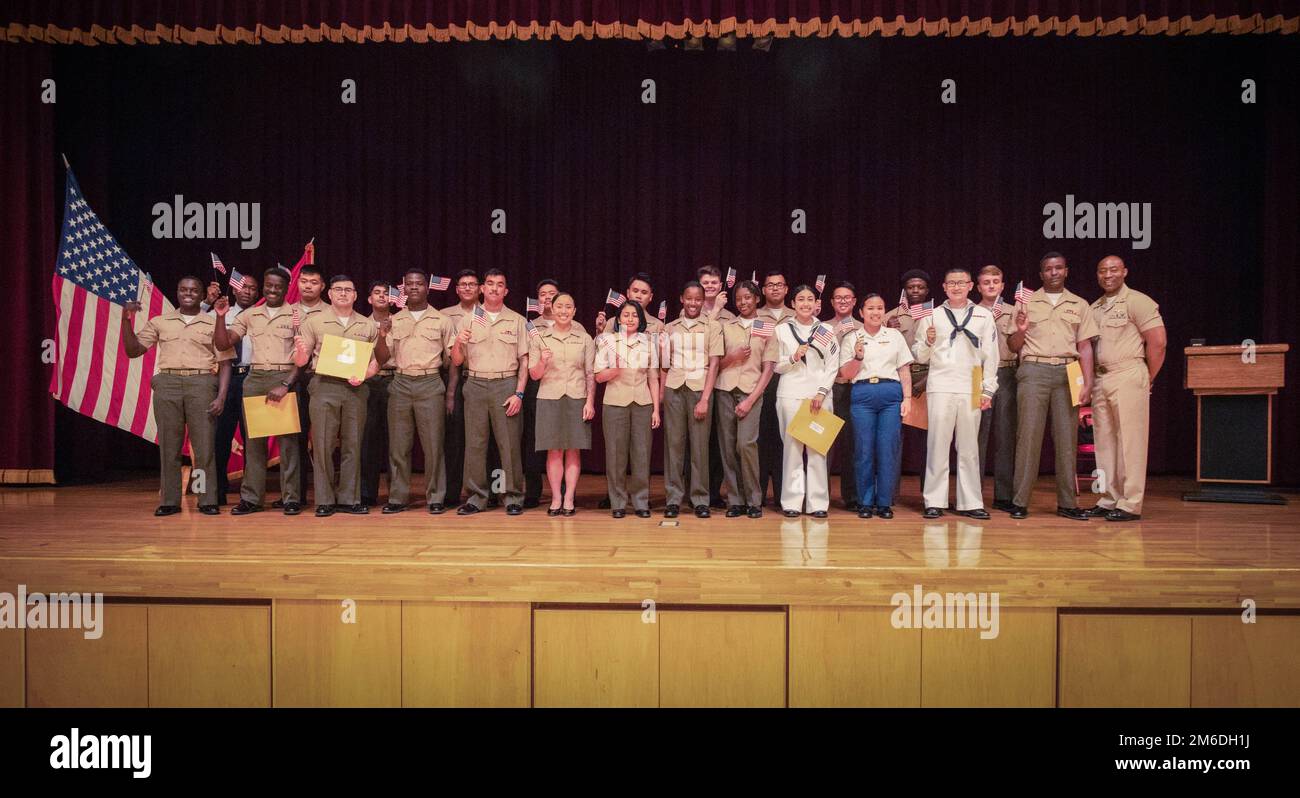 U.S. service members pose for a group photo during a naturalization ...