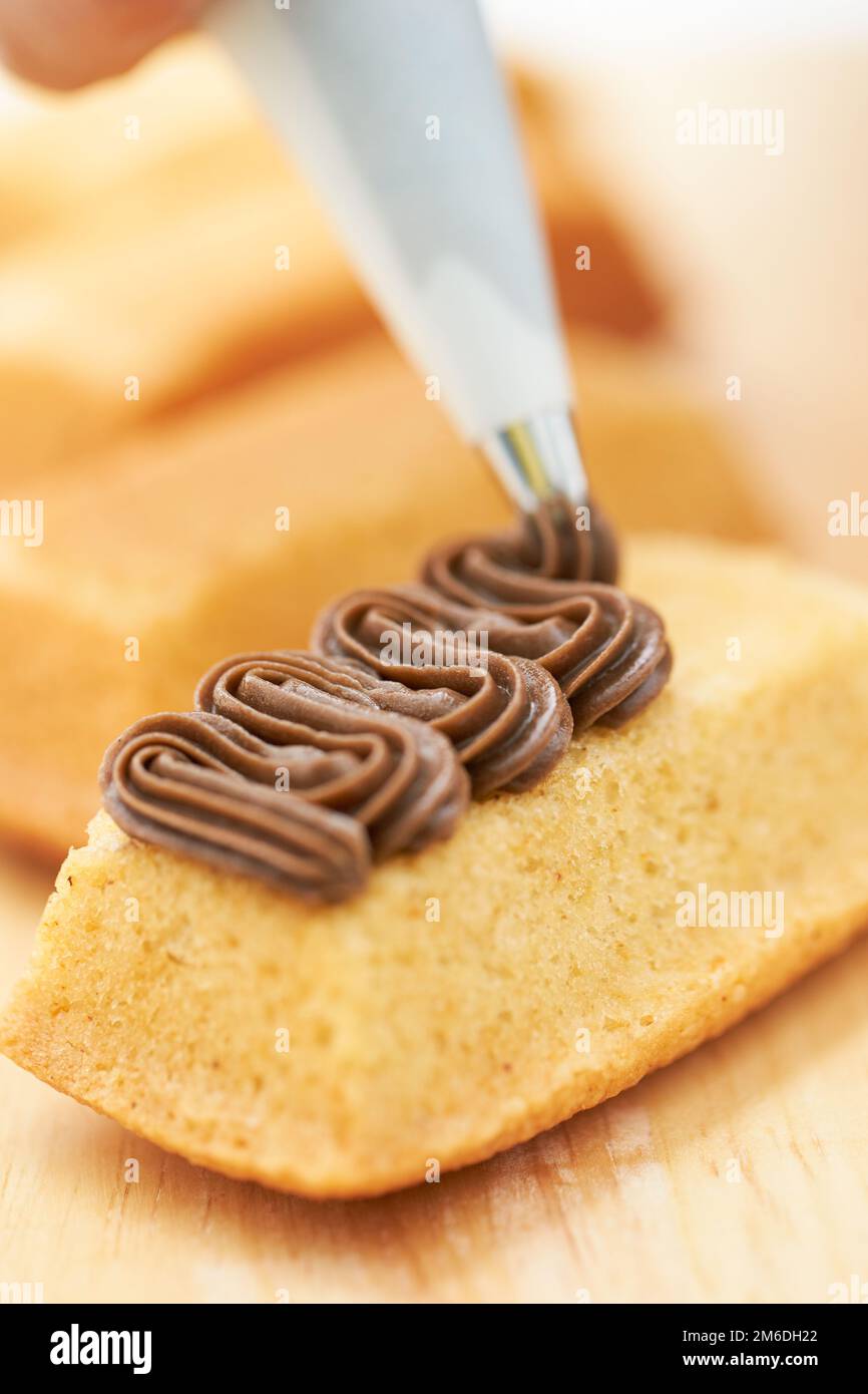 Spread whipped cream on bread Stock Photo - Alamy