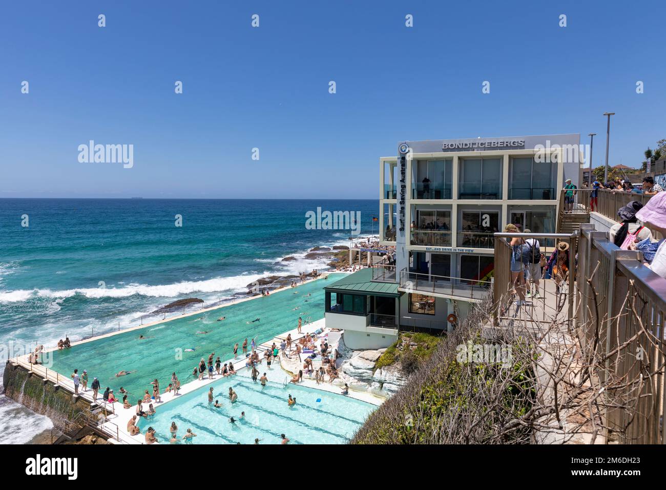Bondi Icebergs clubhouse and outdoor swimming pools, busy with people ...