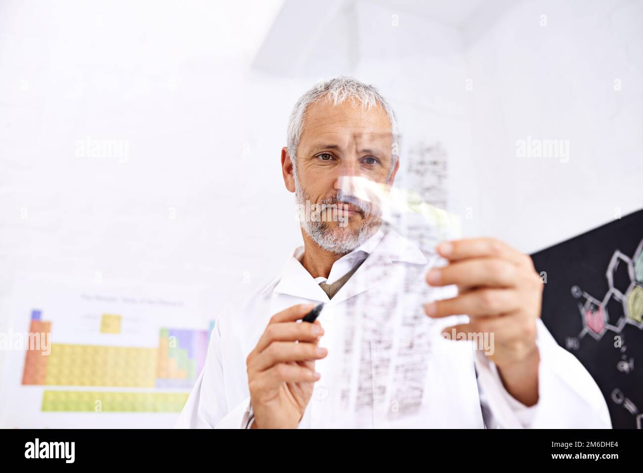 Unlocking DNA mysteries. a male scientist analyzing the results of a ...