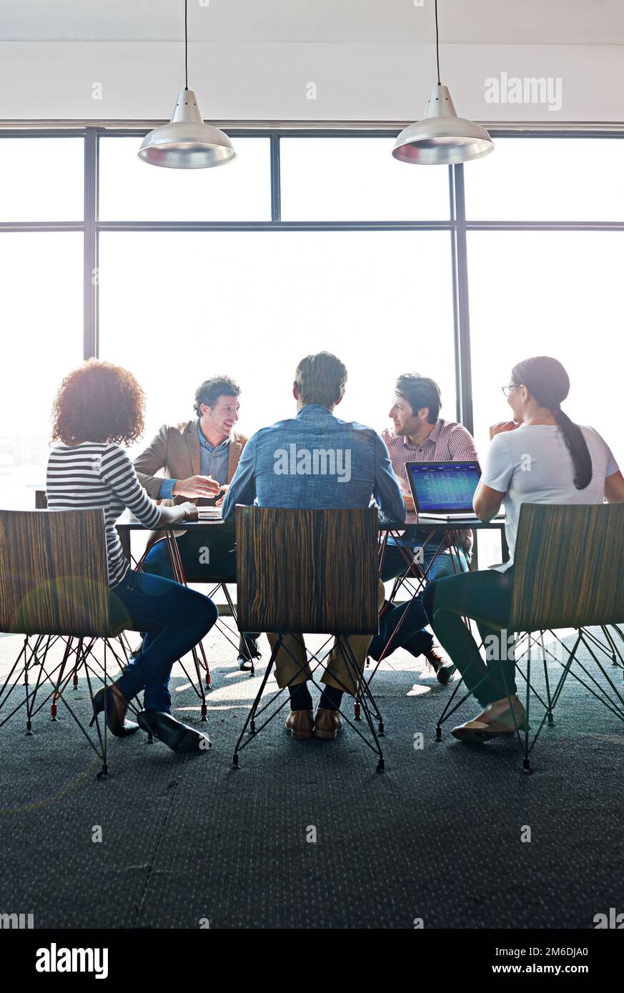 The idea pitch. a group of coworkers having a brainstorming session in ...