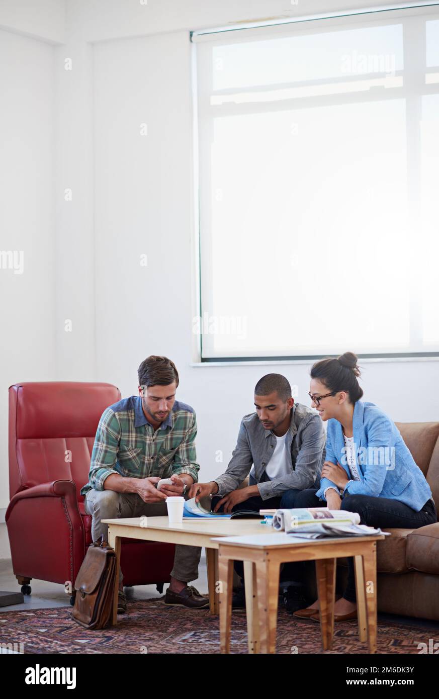 Casual meetings are productive. a group of designers having a meeting ...