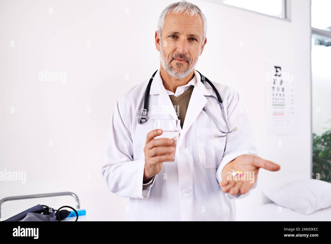 Prescribing you the best medicine. Portrait of a mature male doctor ...