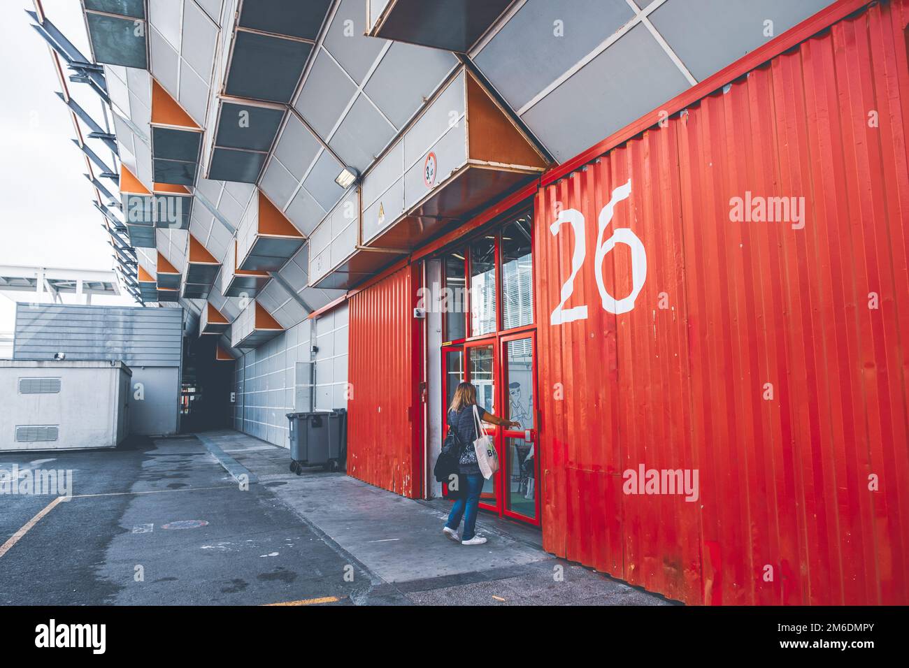 Woman entering in one of the numbered buildings of the exhibition ...
