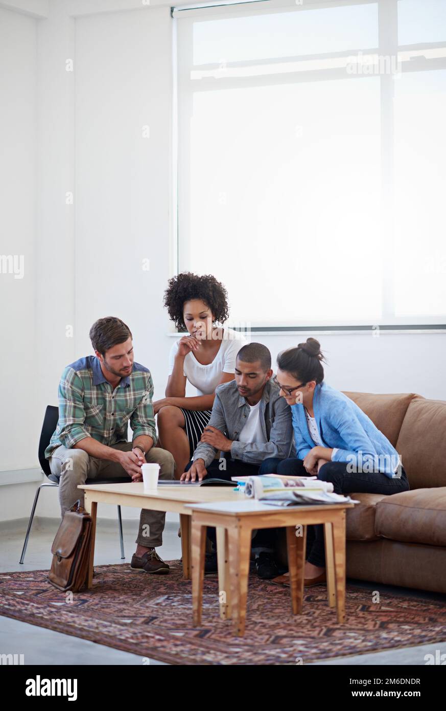 The ideas are coming now. a group of designers having a meeting around ...