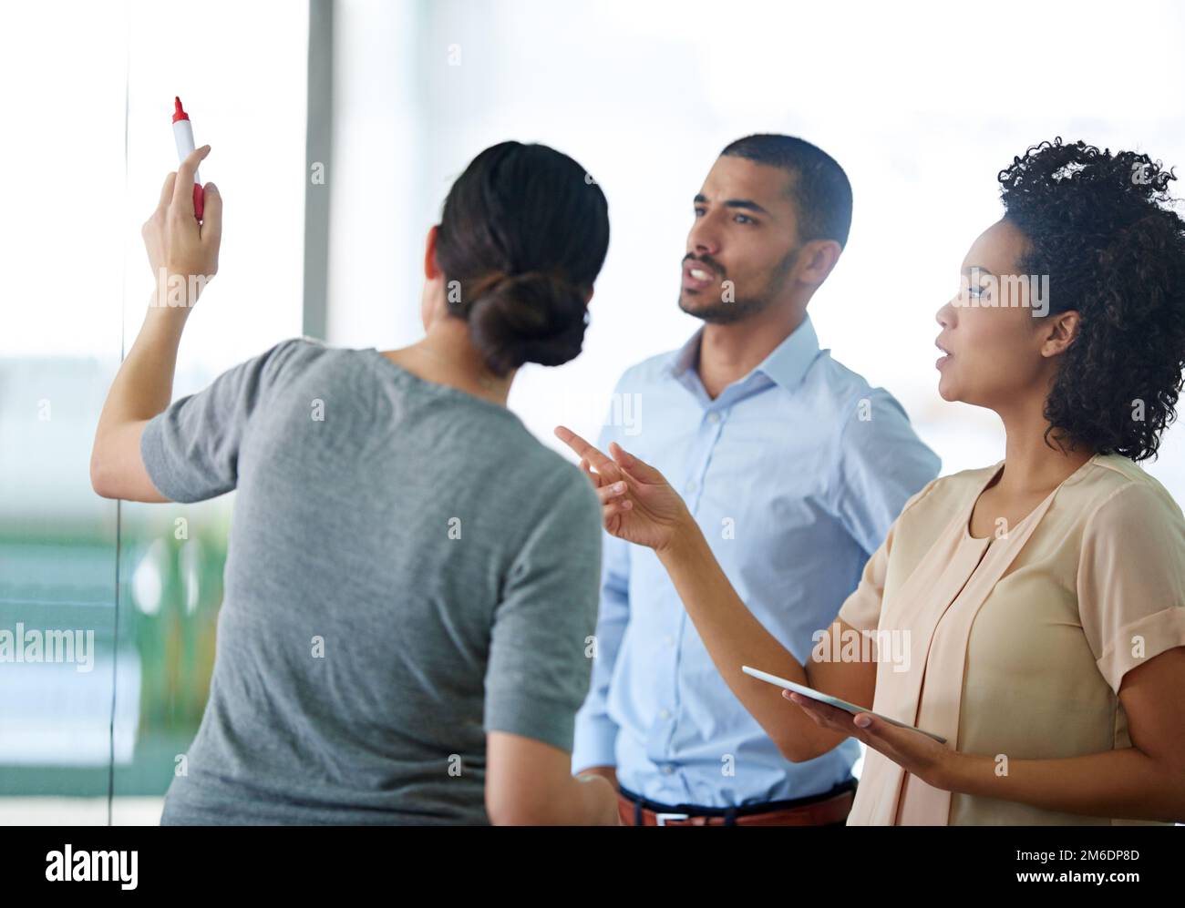 Putting ideas into practice. a diverse group of coworkers brainstorming ...