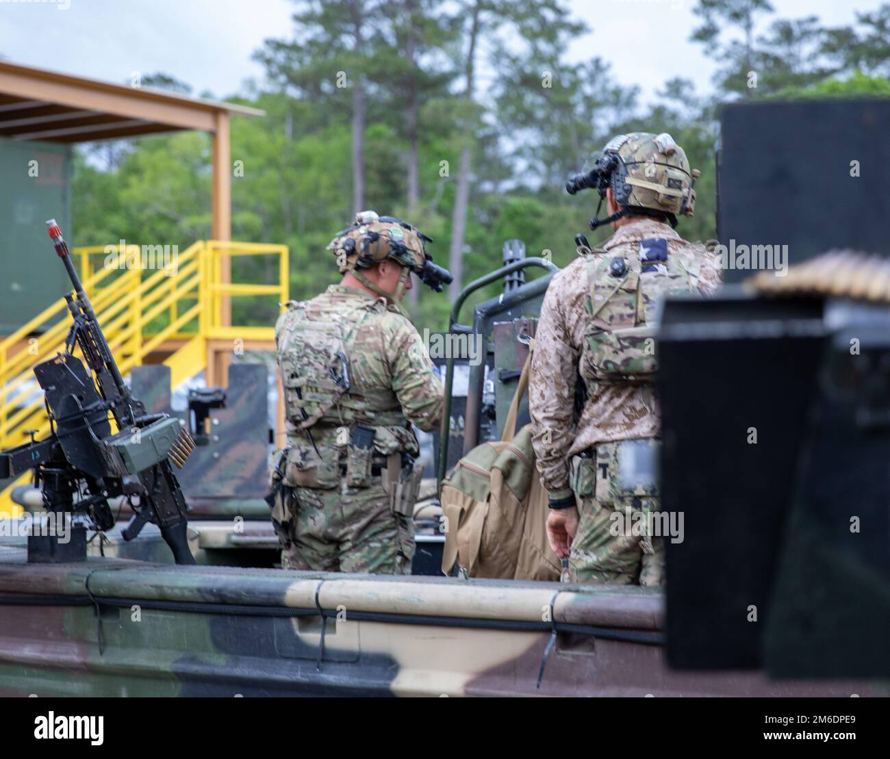 U.S. service members prepare their equipment on a U.S. Navy special ...