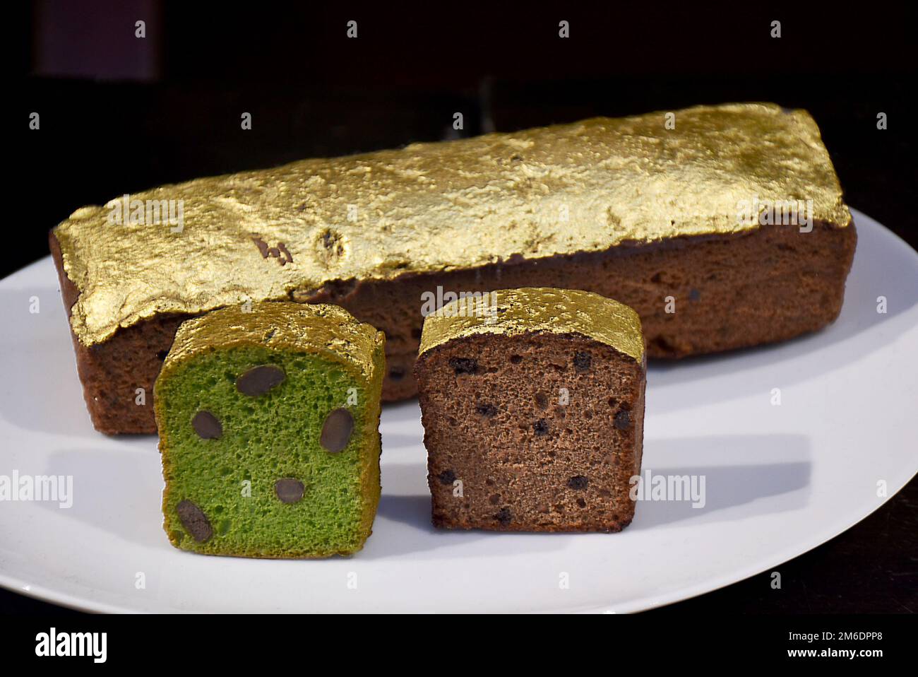 Matcha cake and chocolate cake decorated with gold leaf, a speciality ...