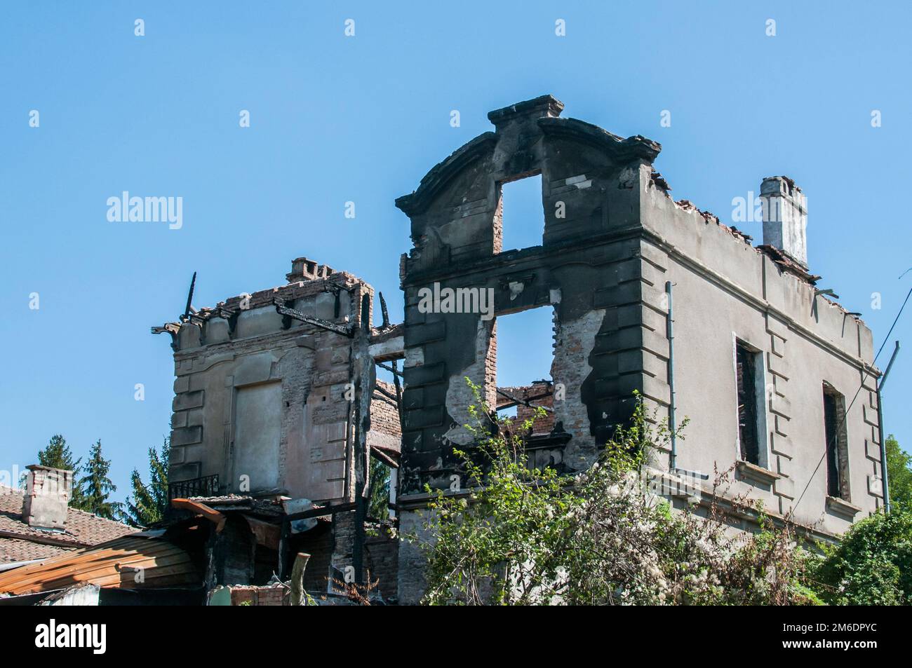 Old burnt and destroyed countryside house closeup in clear sunny day ...