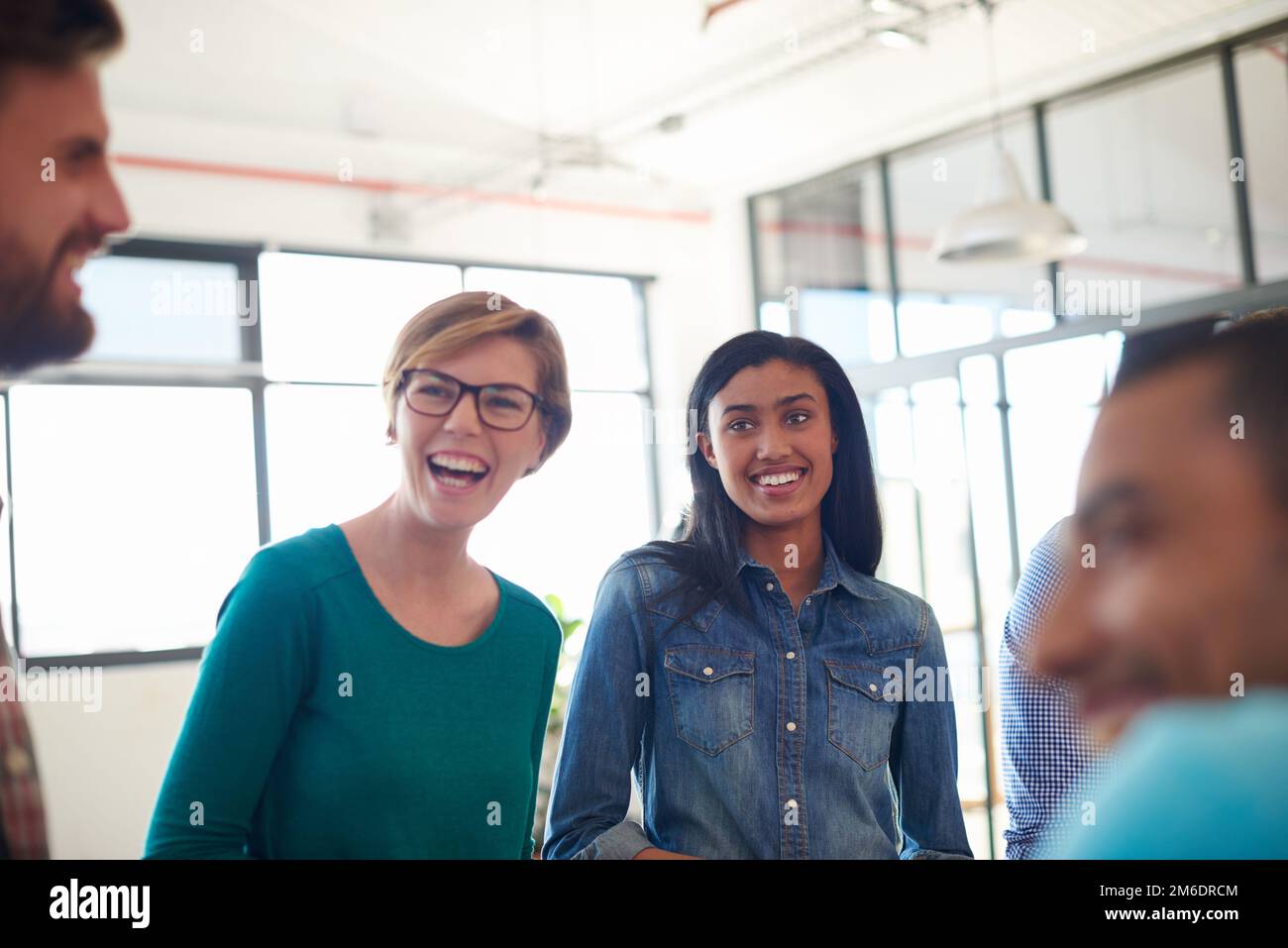 An informal business meeting. A group of informal businesspeople in a ...