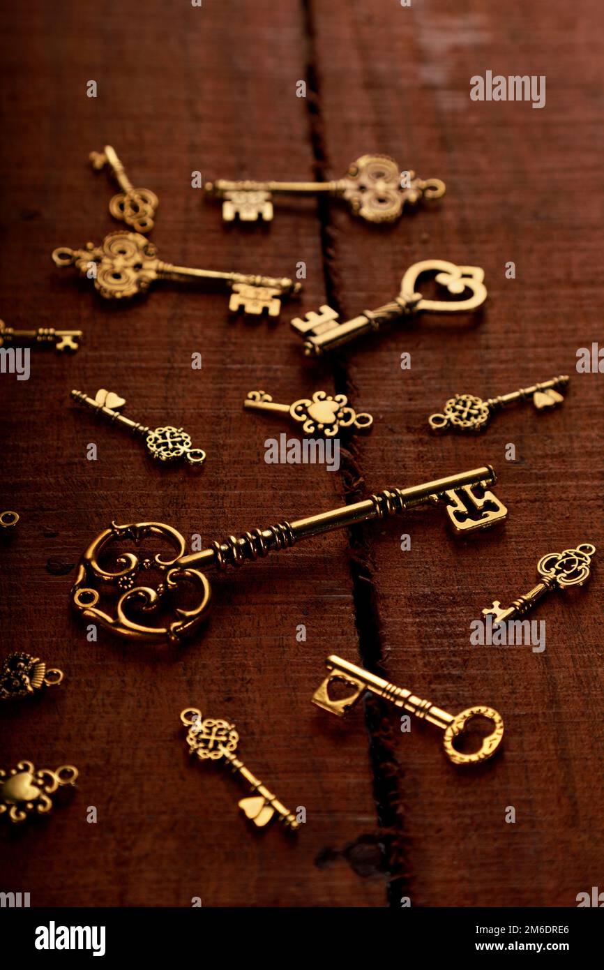 Group of Golden Antique Keys on an old Wood Background Stock Photo - Alamy