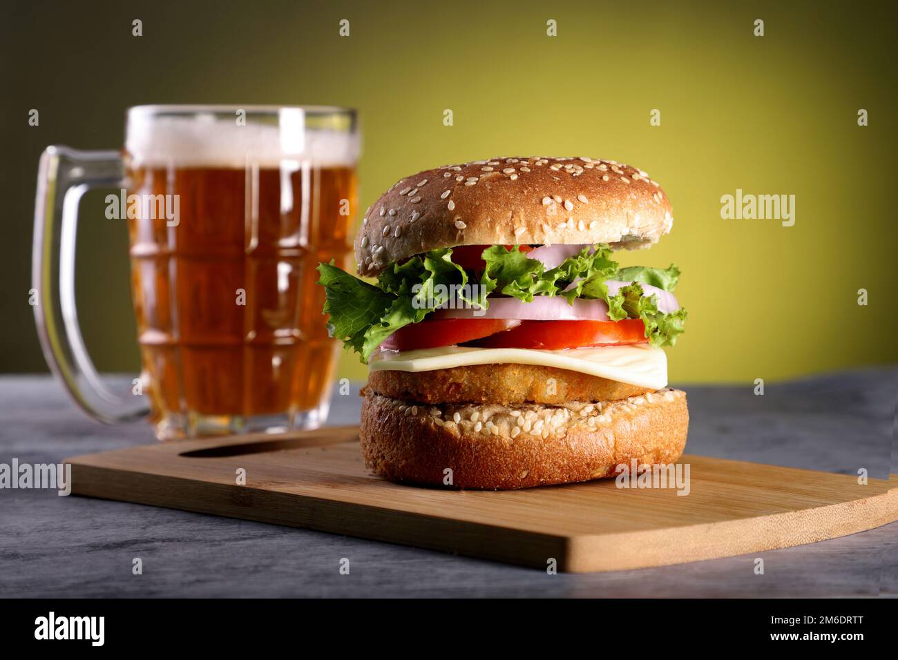 Fast Food Burger with a Beer Mug with yellow background Stock Photo - Alamy