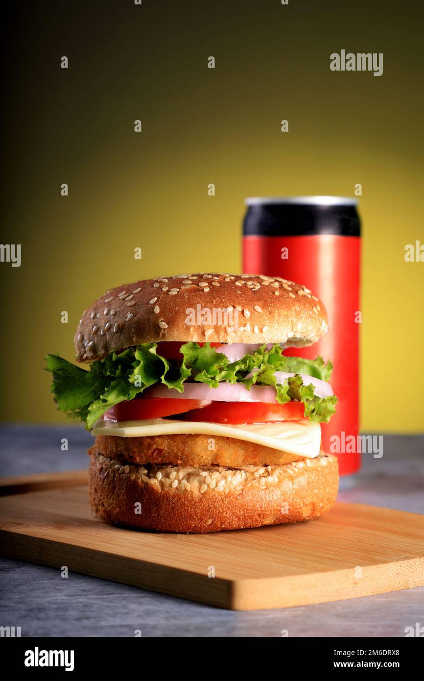 Fast Food Burger with a Cold Drink Can Stock Photo - Alamy