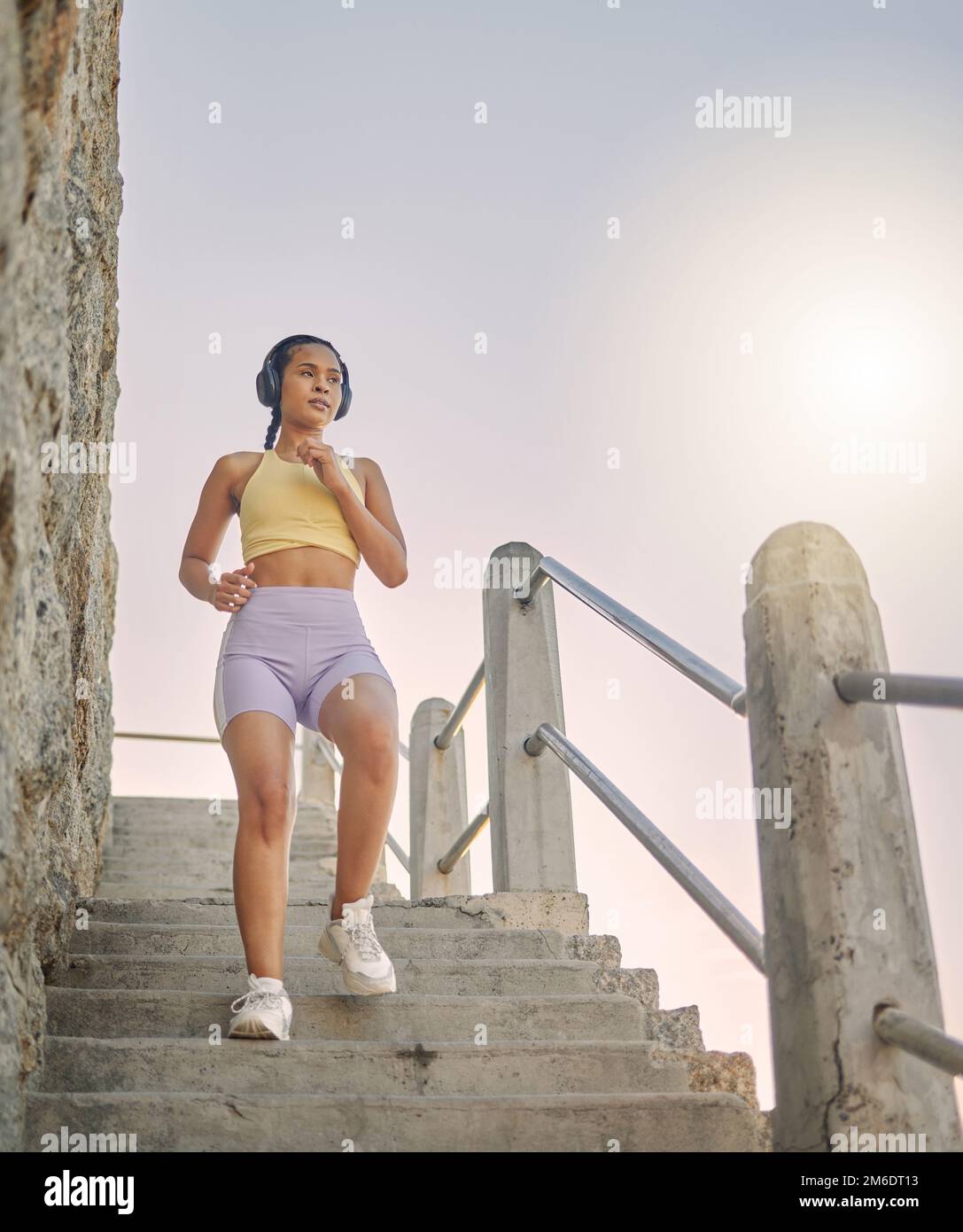 Fitness, podcast or woman running on steps for cardio workout, training ...