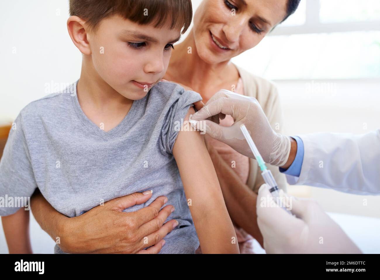 This wont hurt I promise. Closeup shot of a young boy receiving an ...