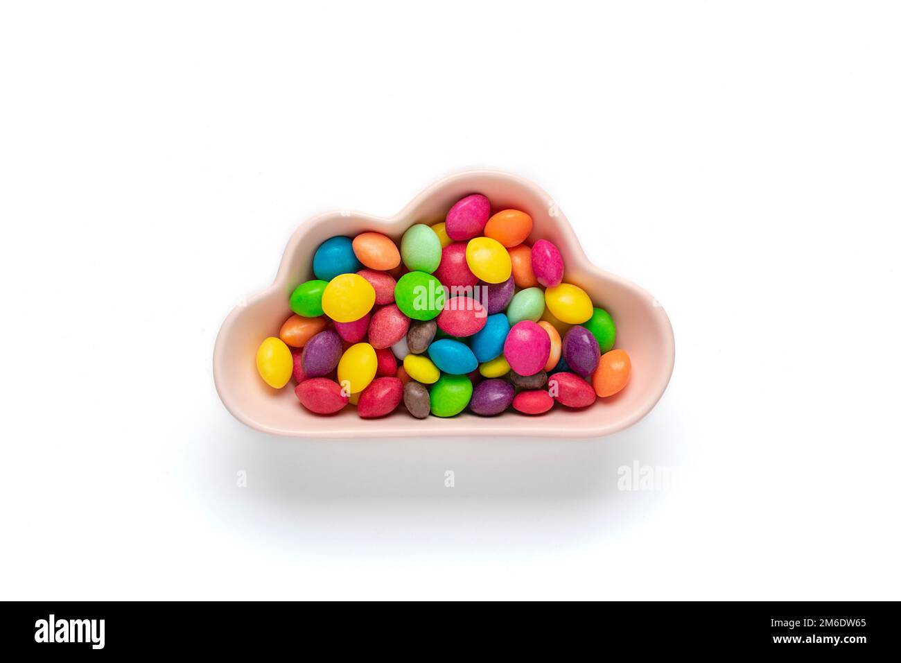 colorful candies - lollipops, meringues, macaroon in bowl in shape of ...