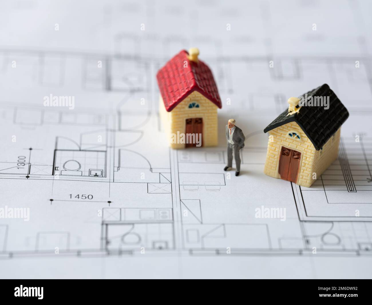 Business man miniature and house miniature on interior drawing Stock ...