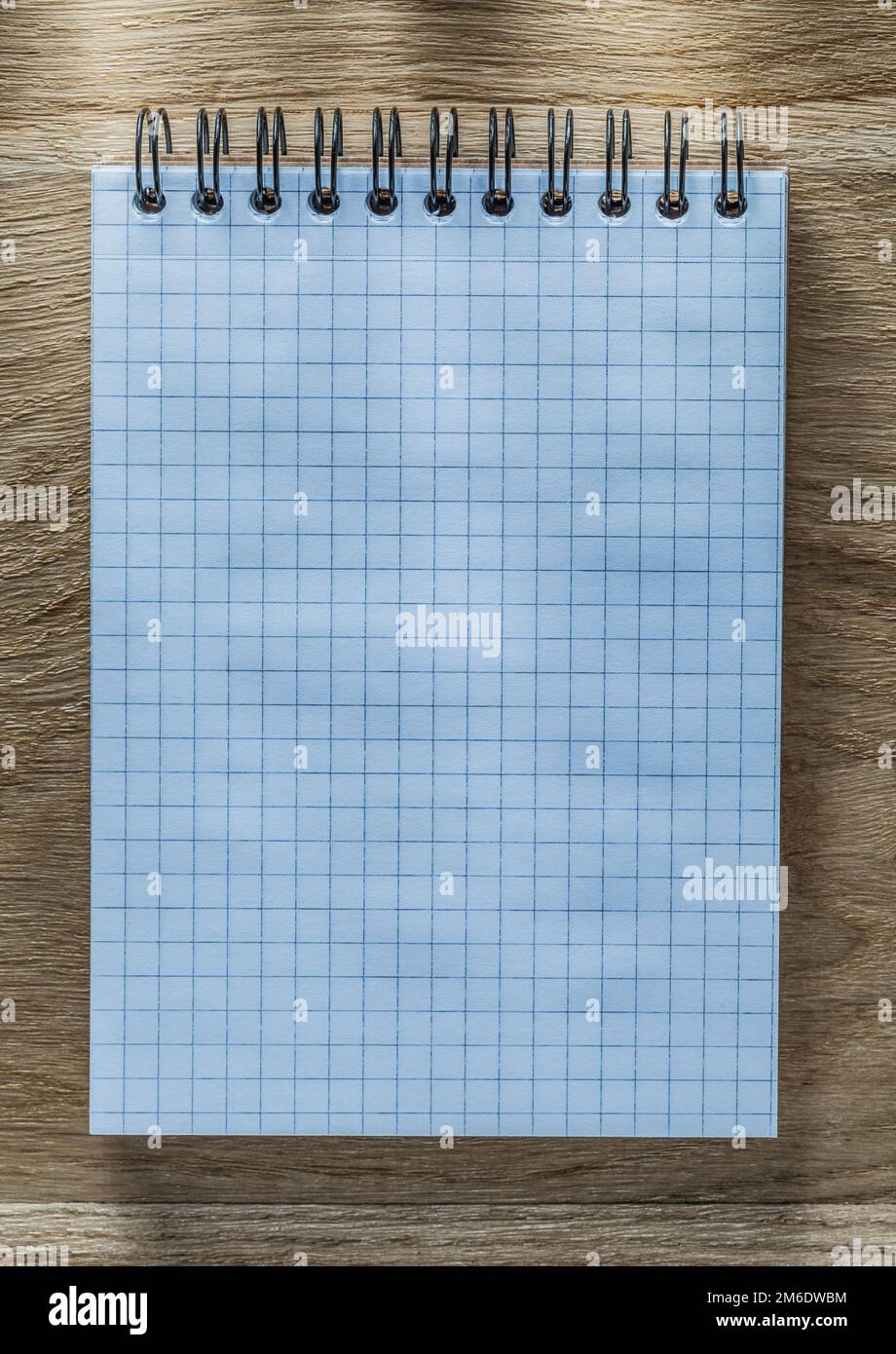 Checked spiral notebook pencil on wooden board directly above Stock ...