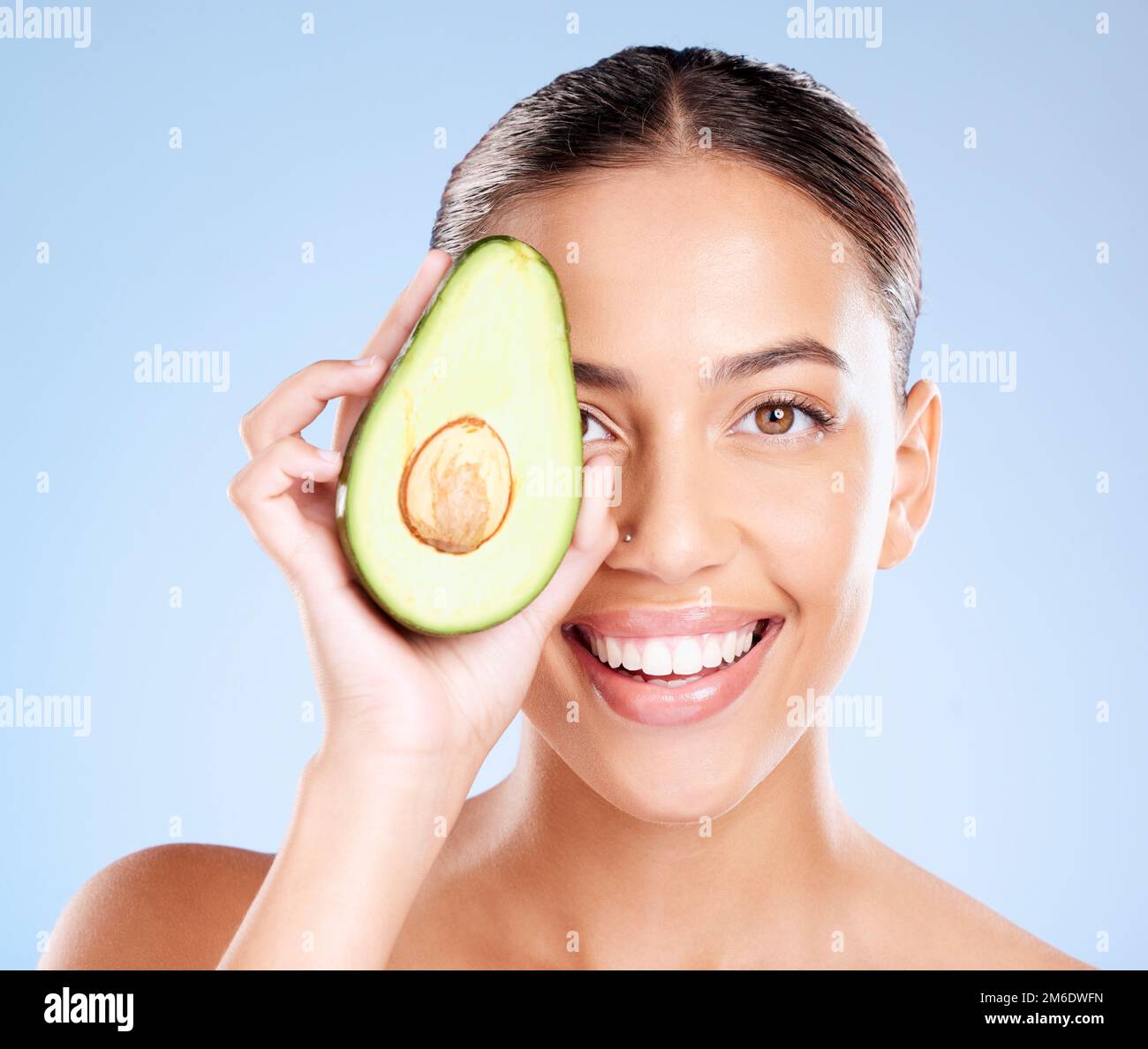 Woman, studio portrait and avocado skincare with smile, health or ...