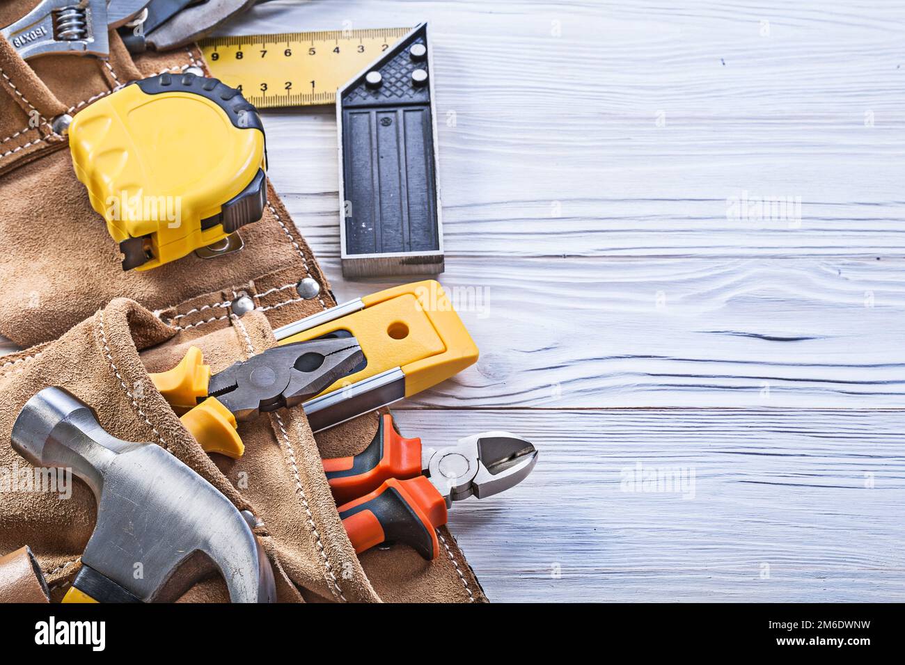 Construction tools in leather building belt on wooden board maintenance ...