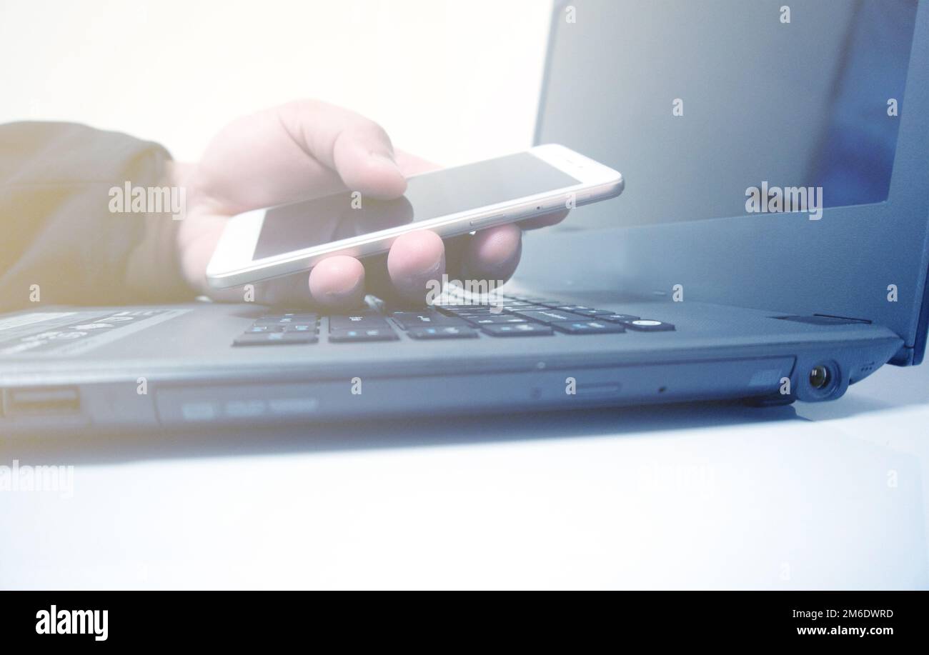 Playing mobile phones in the office Stock Photo - Alamy