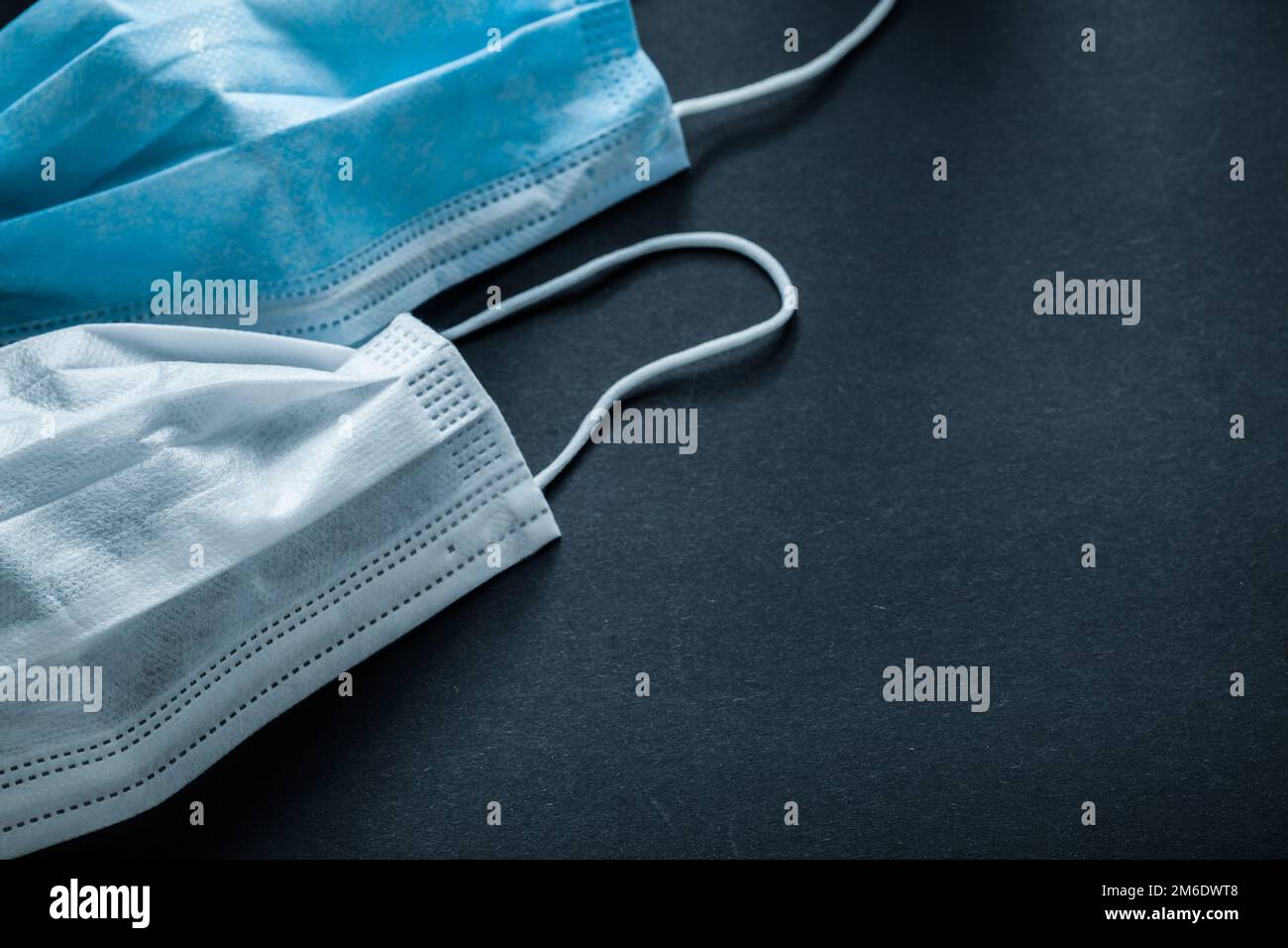 Disposable face masks on black background medicine concept Stock Photo ...