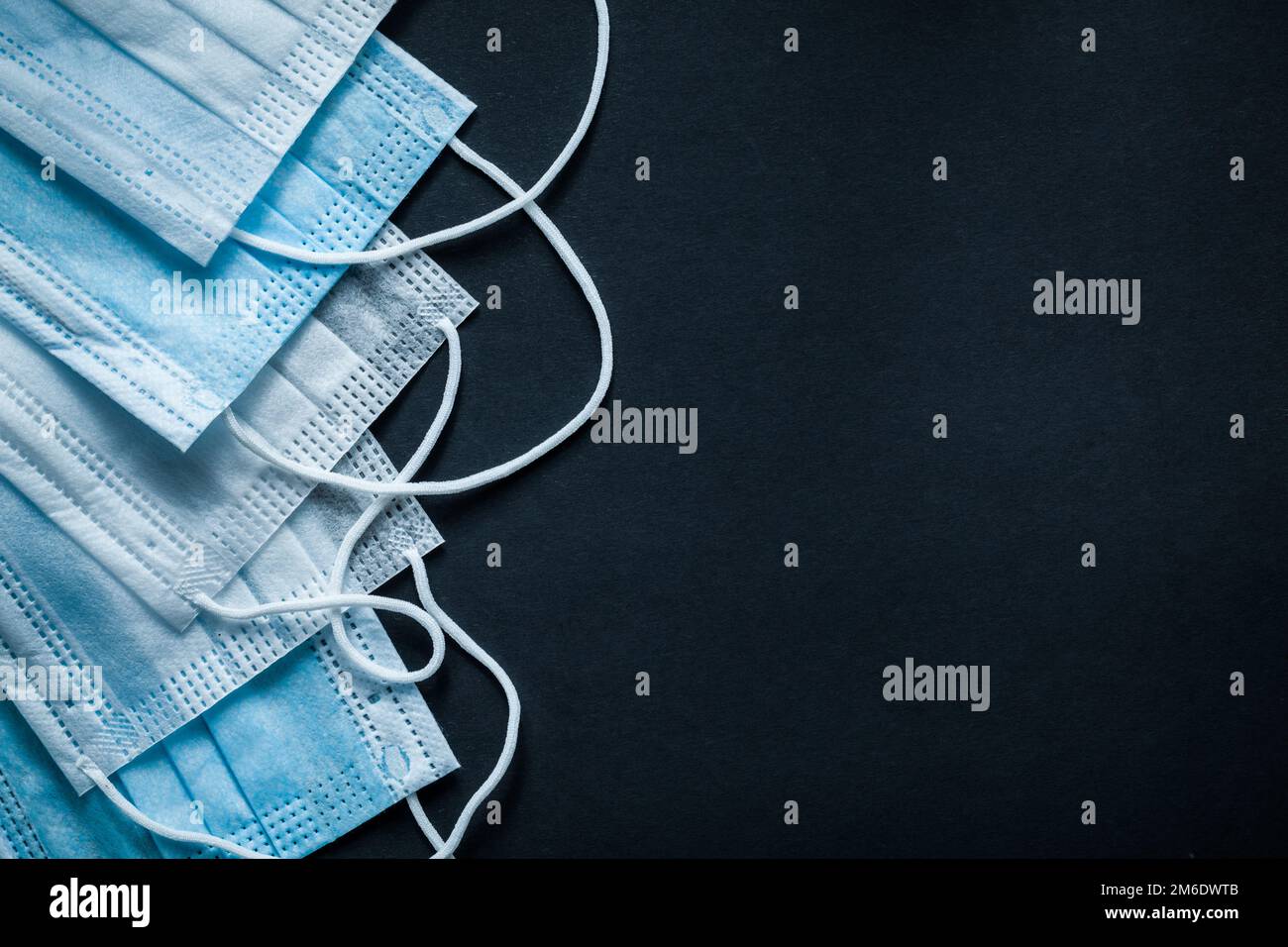Disposable medical masks on black background copy space Stock Photo - Alamy