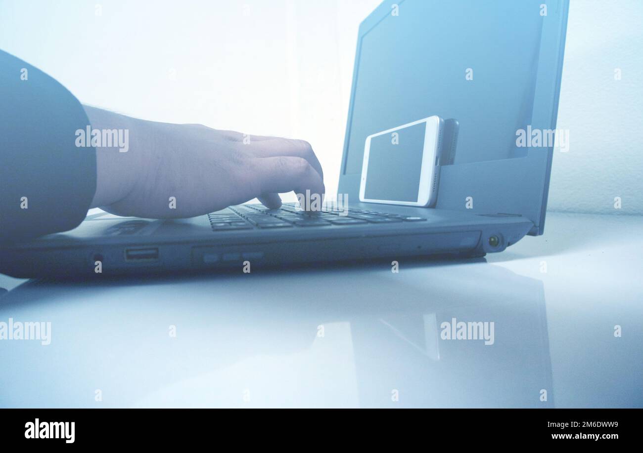 Using a laptop for office work Stock Photo - Alamy