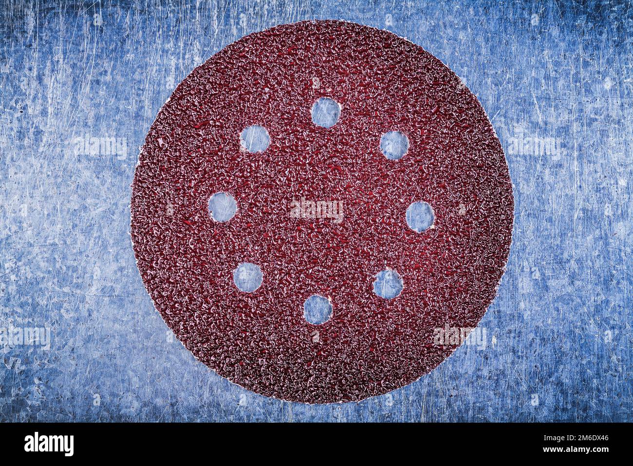 Grinding disc on scratched metallic background Stock Photo - Alamy