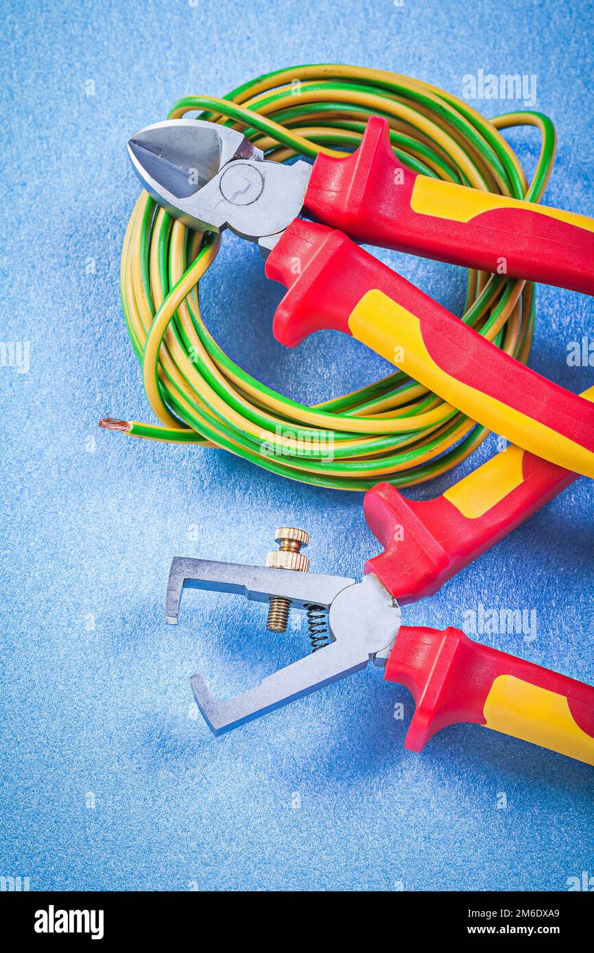 Insulation strippers electrical cable nippers on blue background ...