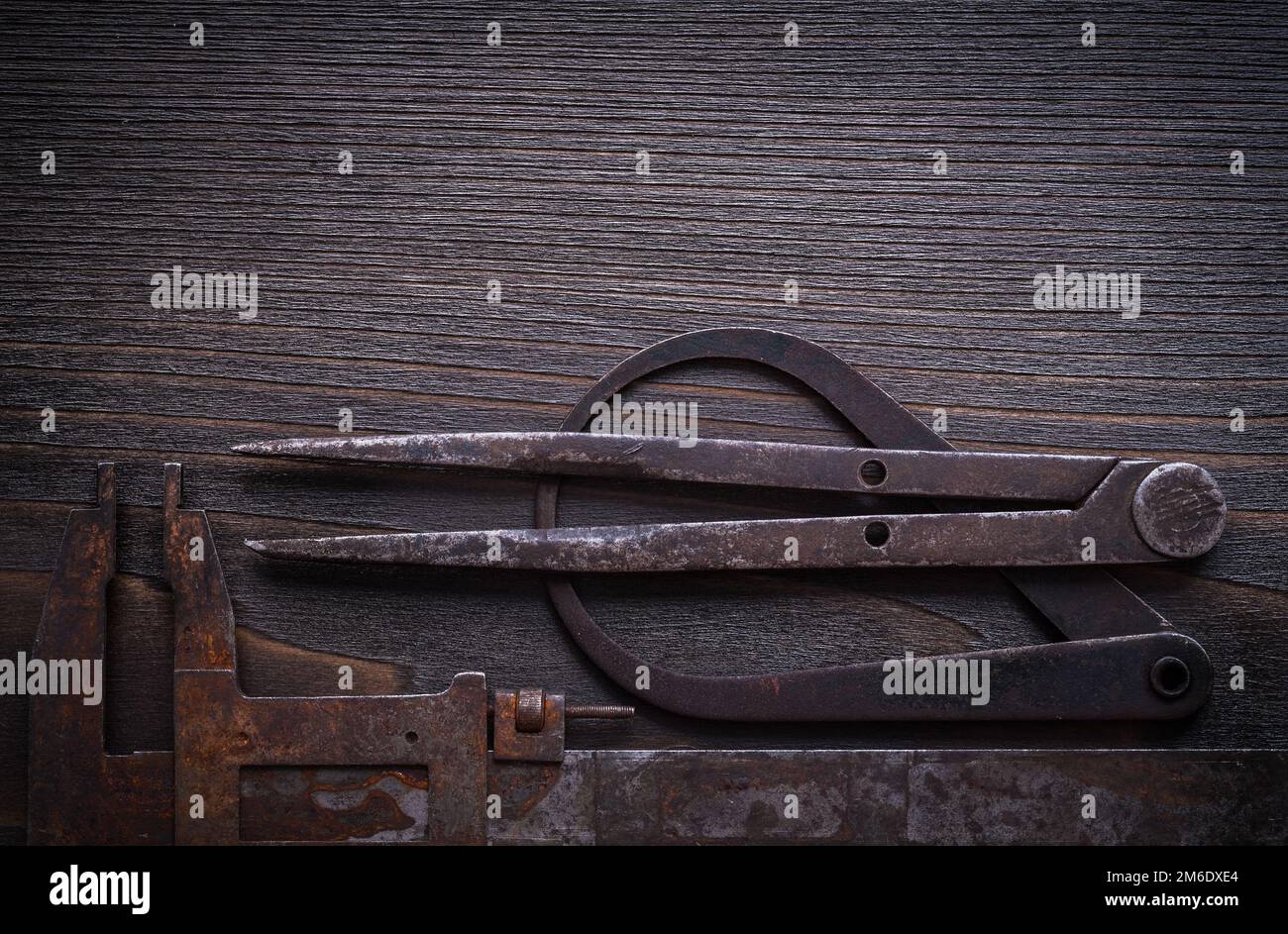 Longstanding calipers on vintage wooden background construction concept ...