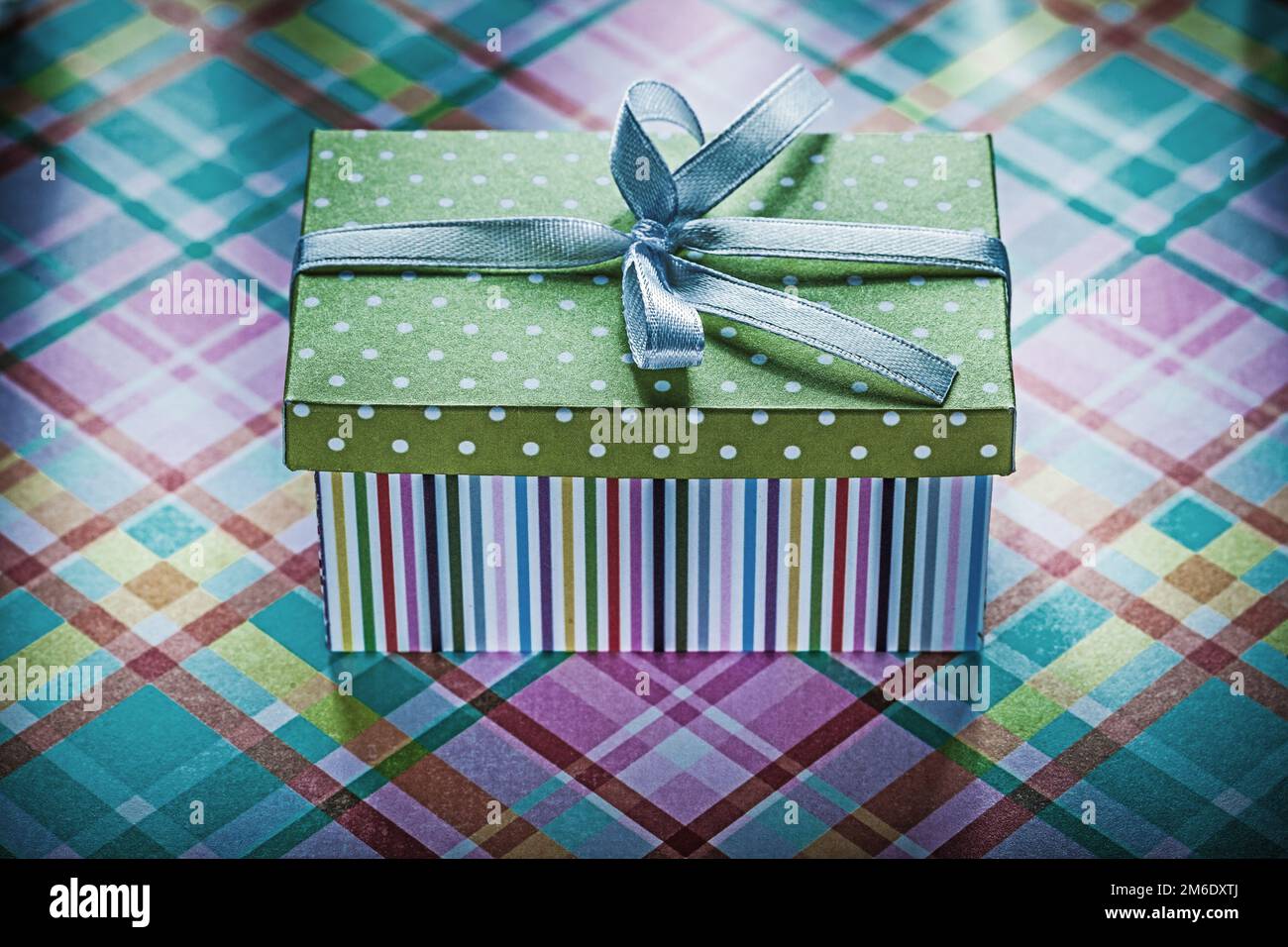Present in cardboard box on checked fabric holidays concept Stock Photo ...